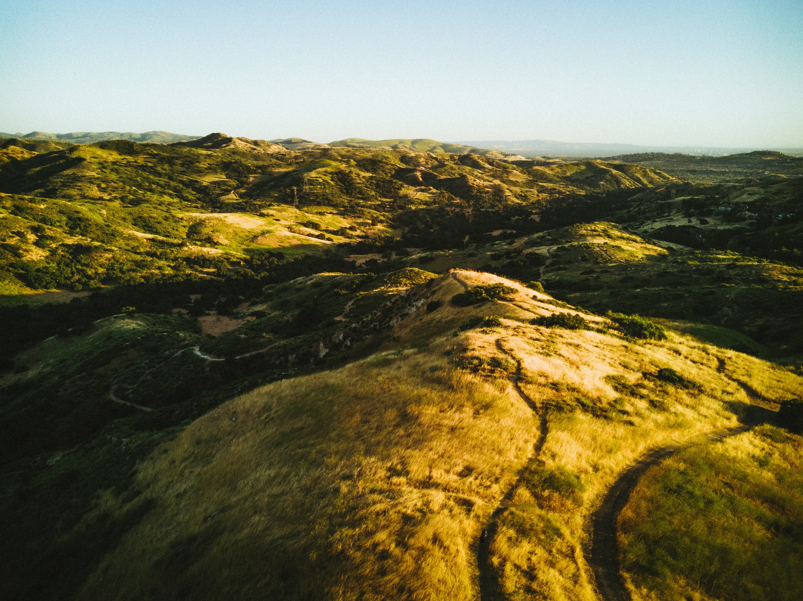 grass covers rolling hillsides in the country, lost in the hills 4k HD ...