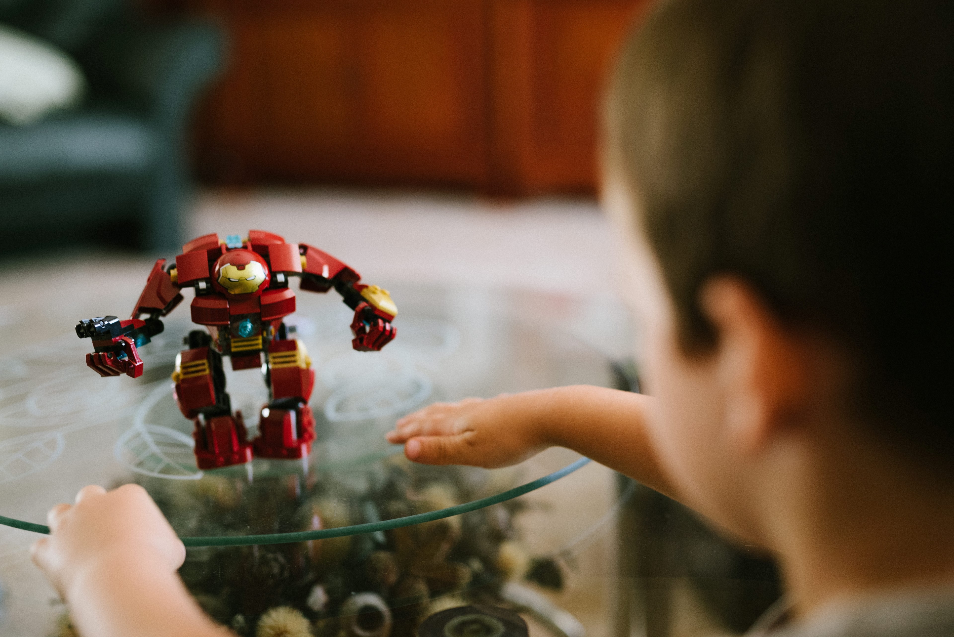 a little boy playing an iron man action figure in epping, iron man 4k ...