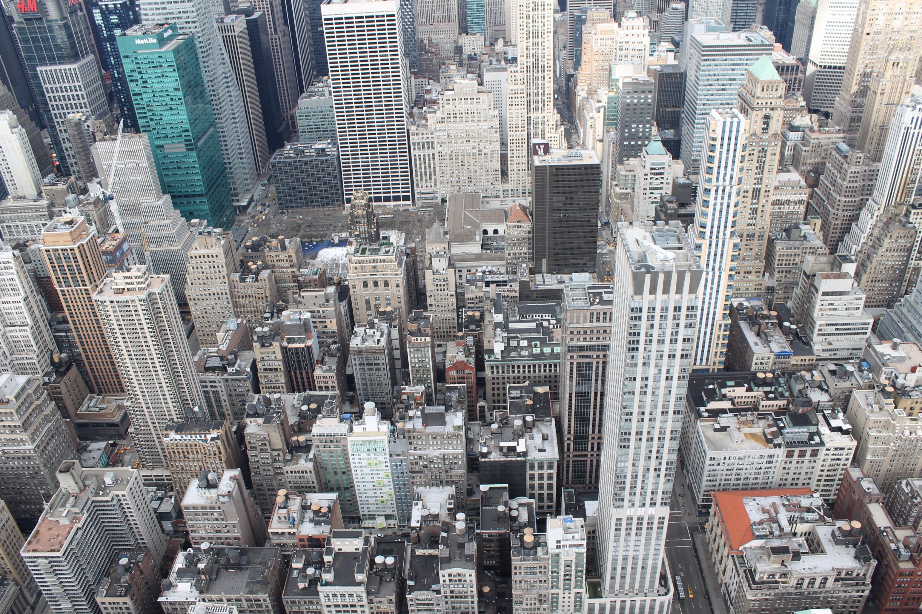 the drone view of a city with tall buildings and cloud line over it ...